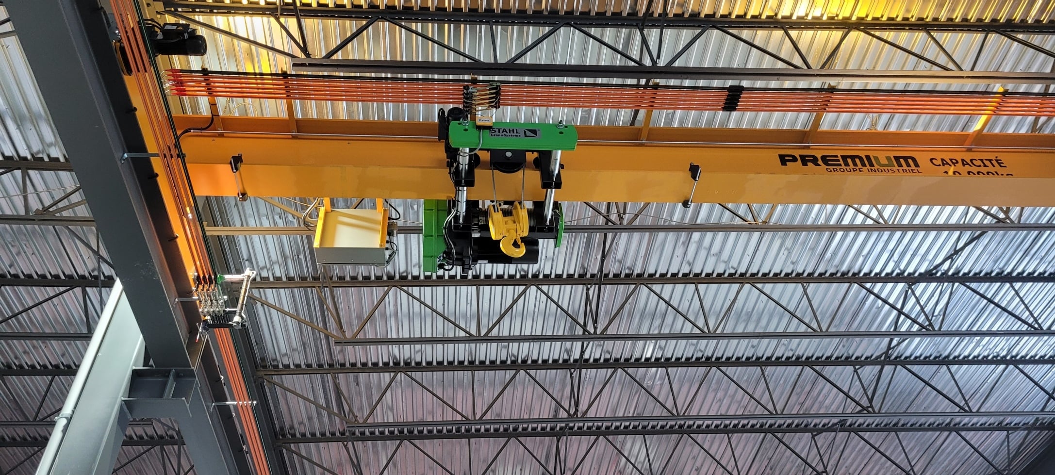Why and when should I add a grounding conductor to my overhead crane?